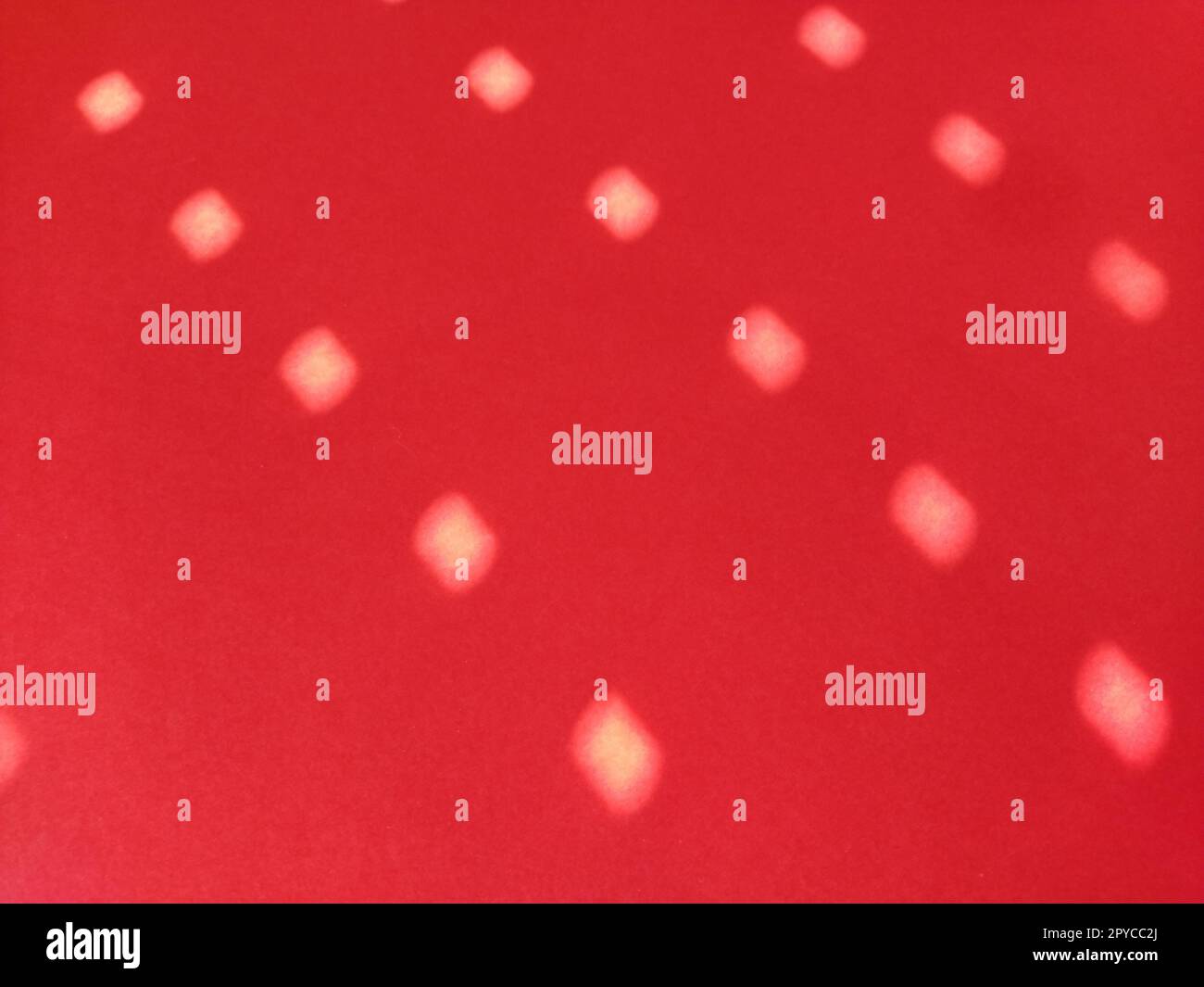 Red background with polka dots. Rays of the sun shining through the ...