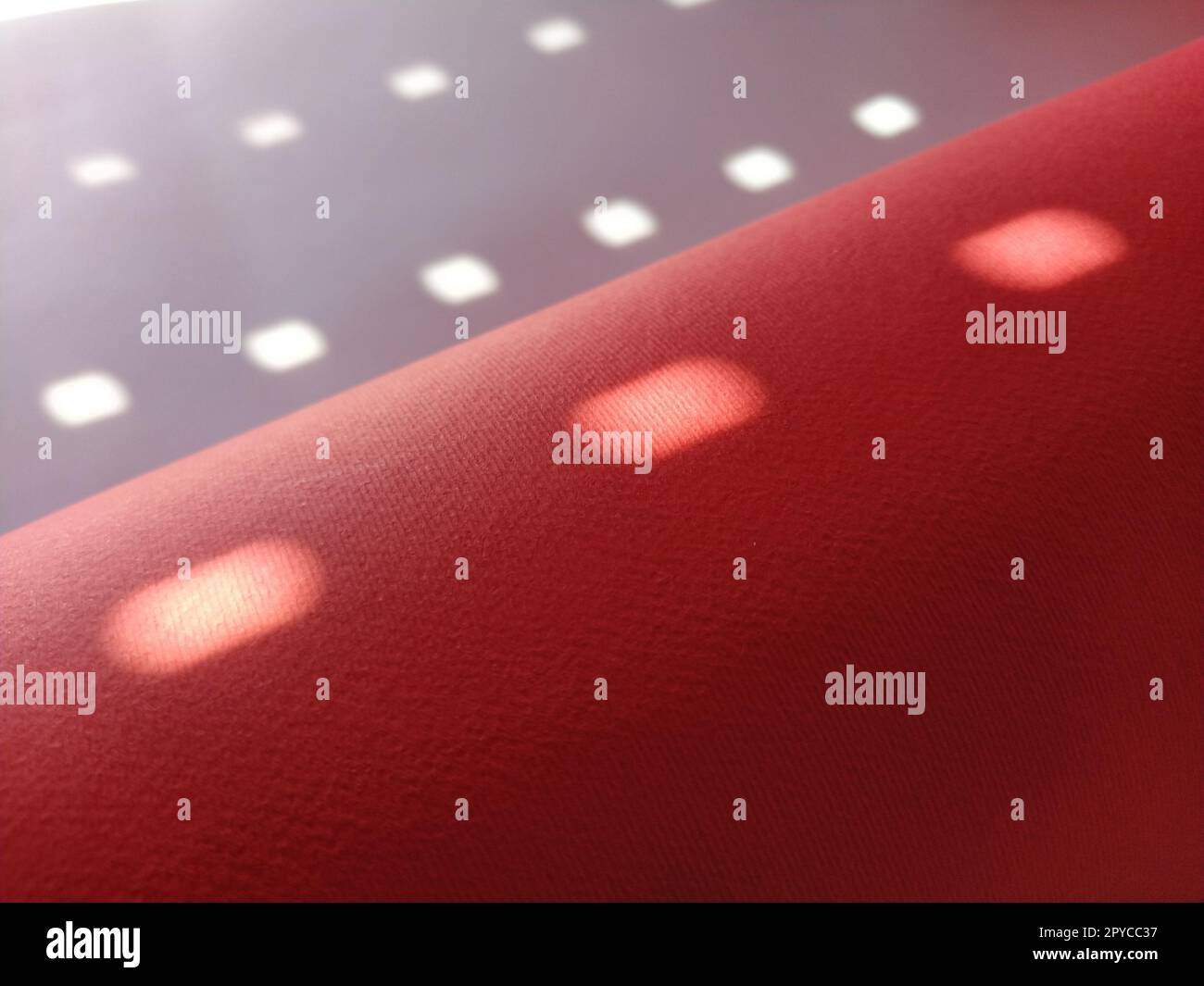 Red background with polka dots. Rays of the sun shining through the ...