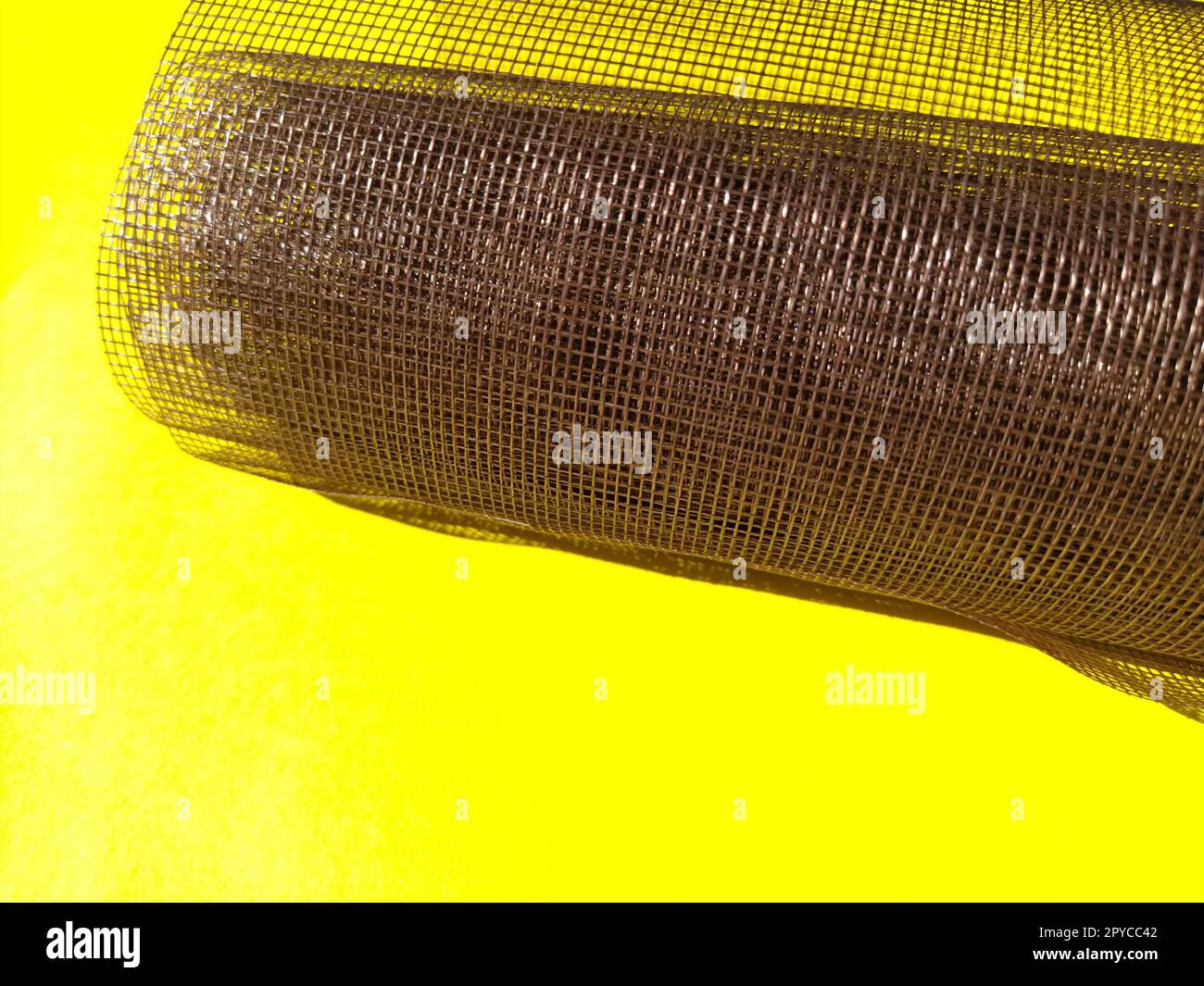 Roll of window screen, closeup. Roll of brown mosquito nets. Barrage ...