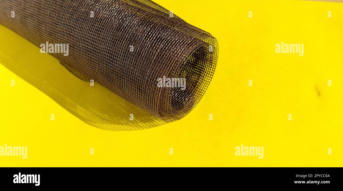 Roll of window screen, closeup. Roll of brown mosquito nets. Barrage ...