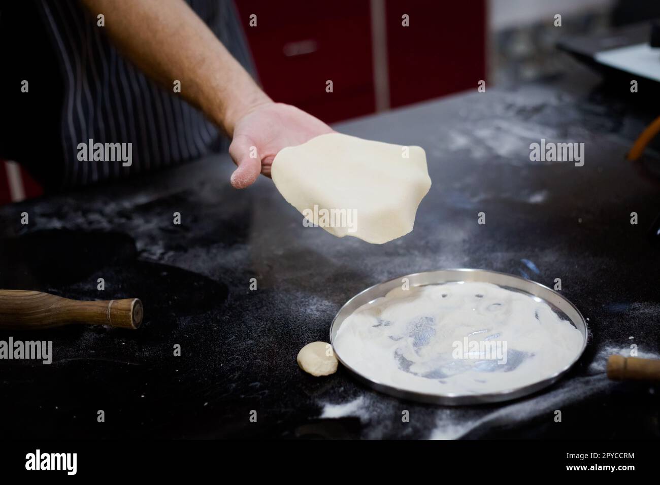 Traditional way of preparing indian food, making roti bread. Picture of ...