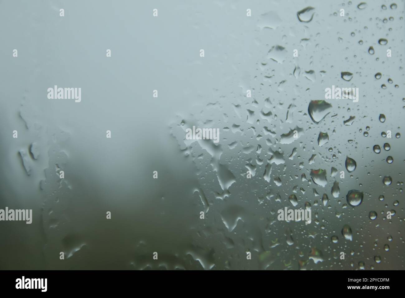 Rain drops on window glasses surface with cloudy background. Natural ...