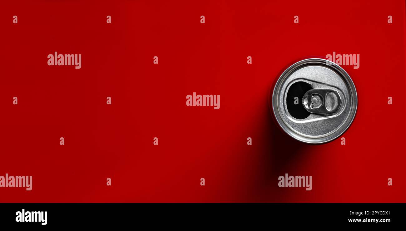 Open drink can directly above on red background. Panoramic image with ...