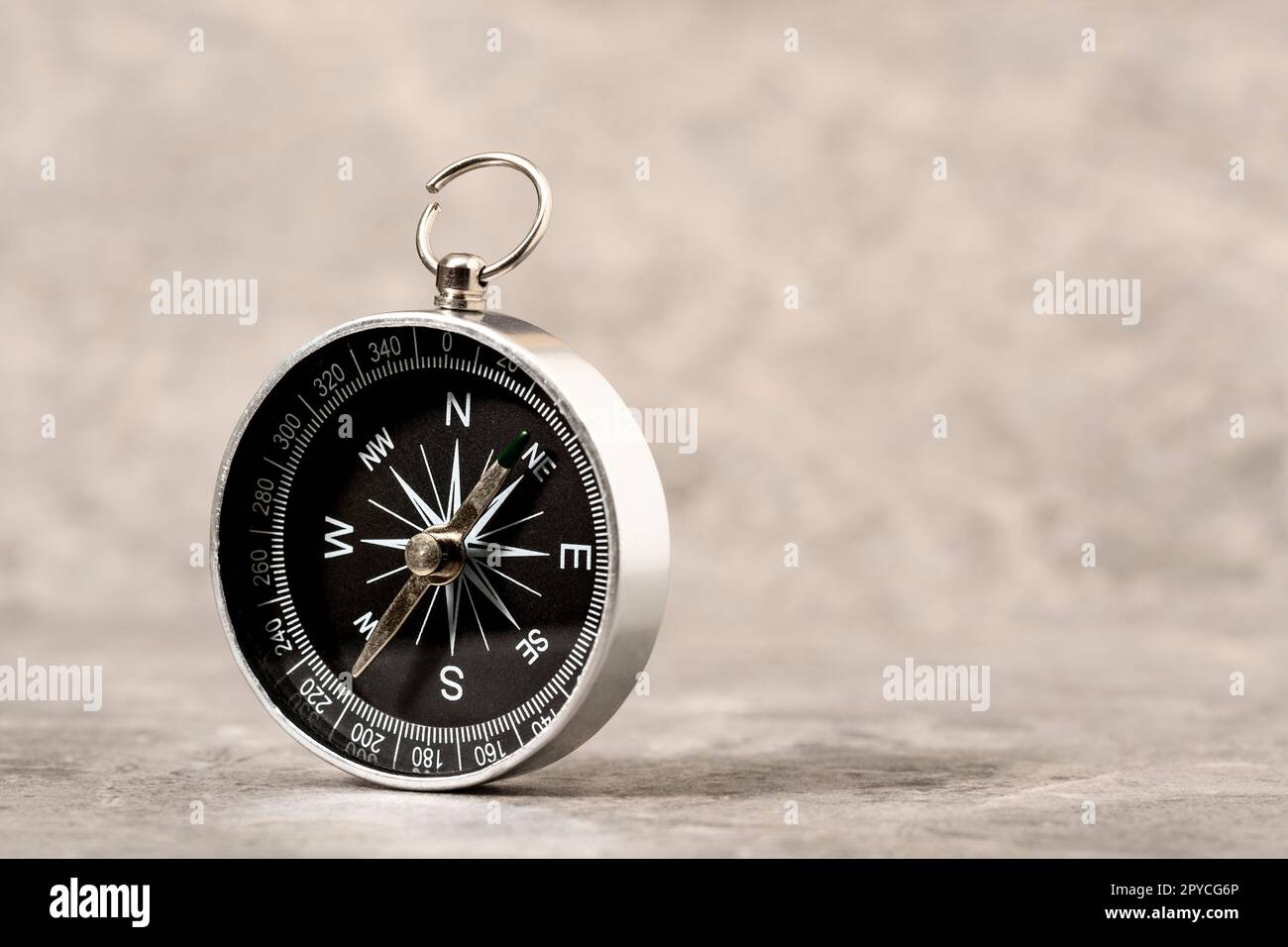 Magnetic compass on a grey stone background Stock Photo - Alamy