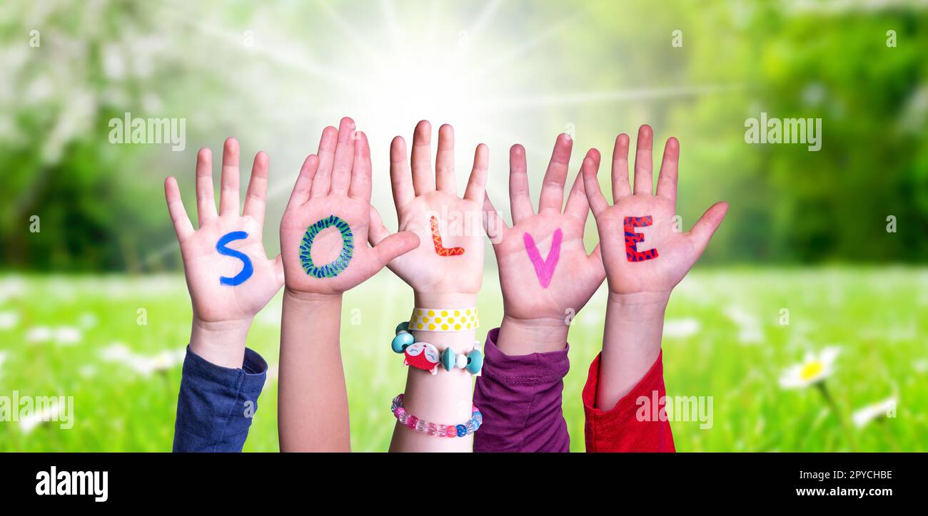 Children Hands Building Word Solve, Grass Meadow Stock Photo - Alamy