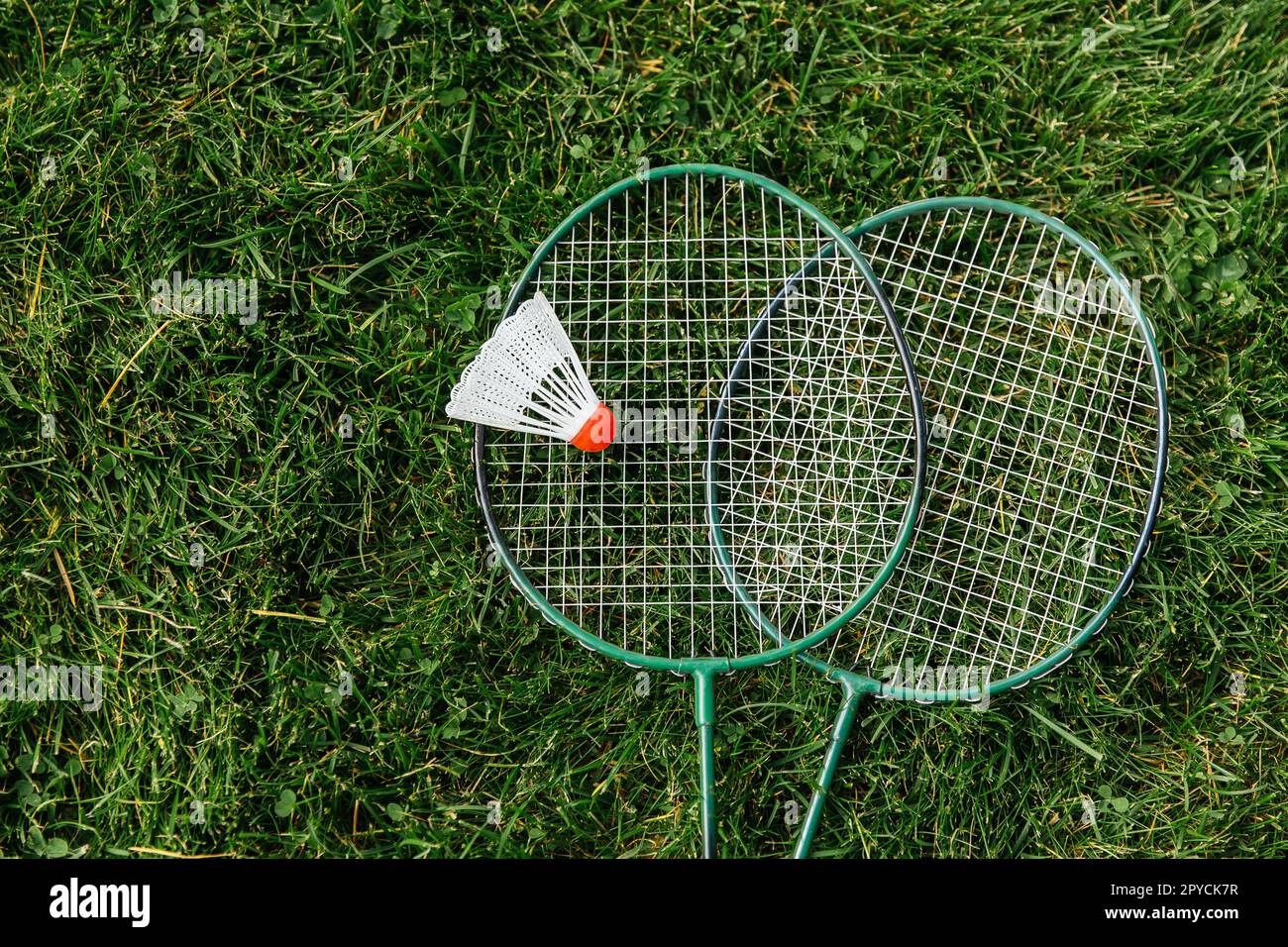 badminton rackets and shuttlecock on grass Stock Photo - Alamy