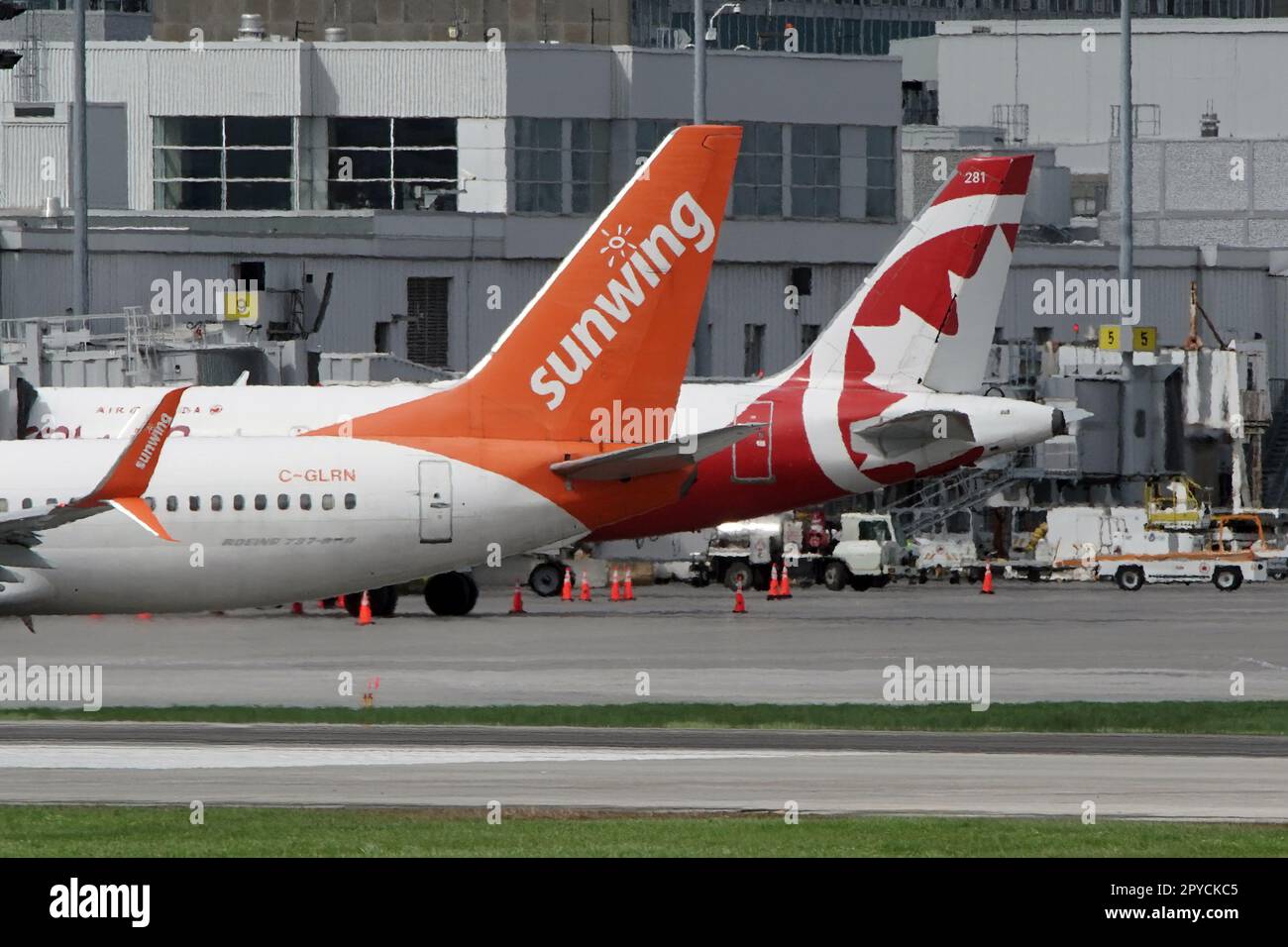 Tail sections of a Sunwing and Air Canada jets Stock Photo - Alamy
