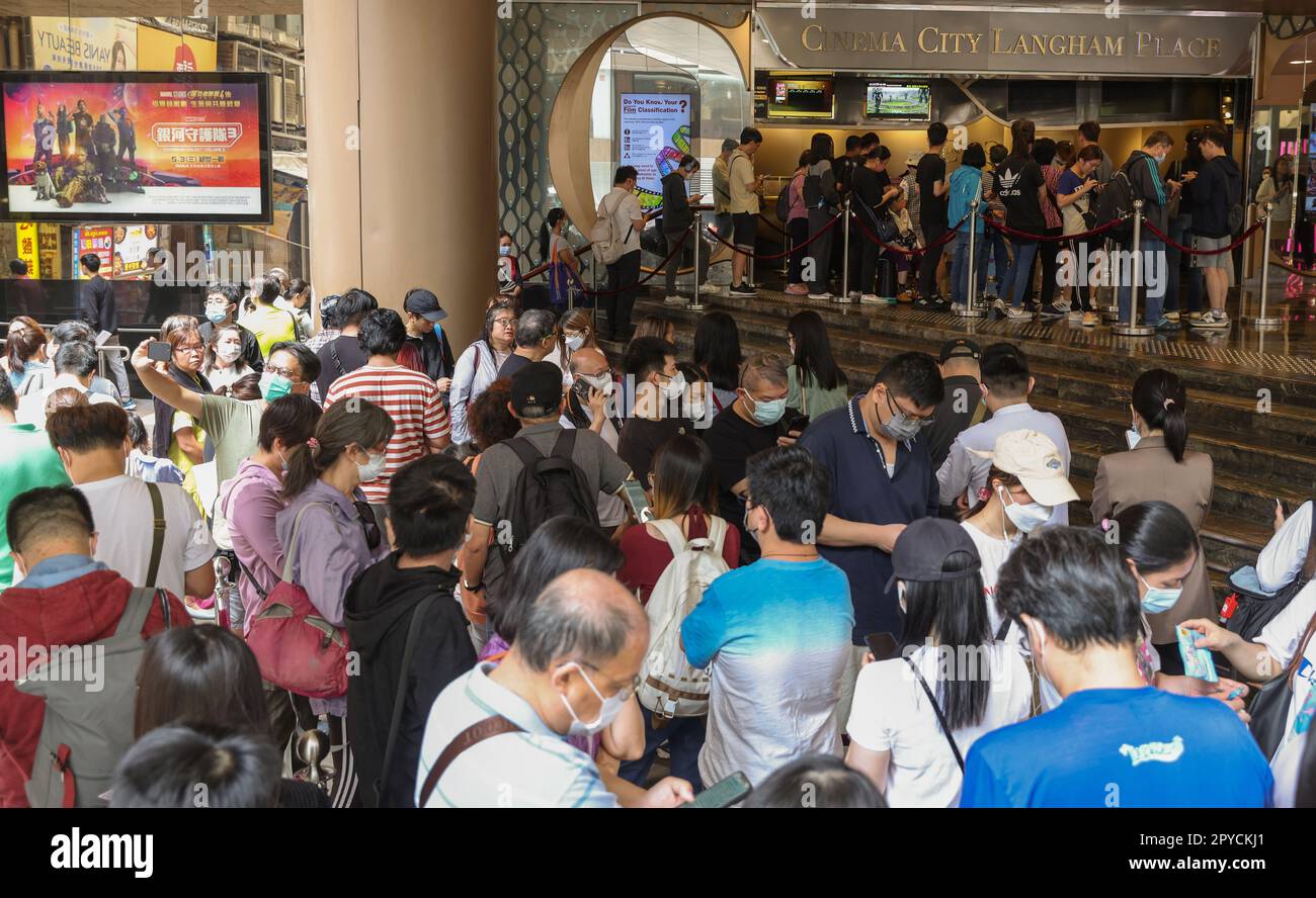 Dozens of people queue up to buy movie tickets outside a cinema in Mong ...