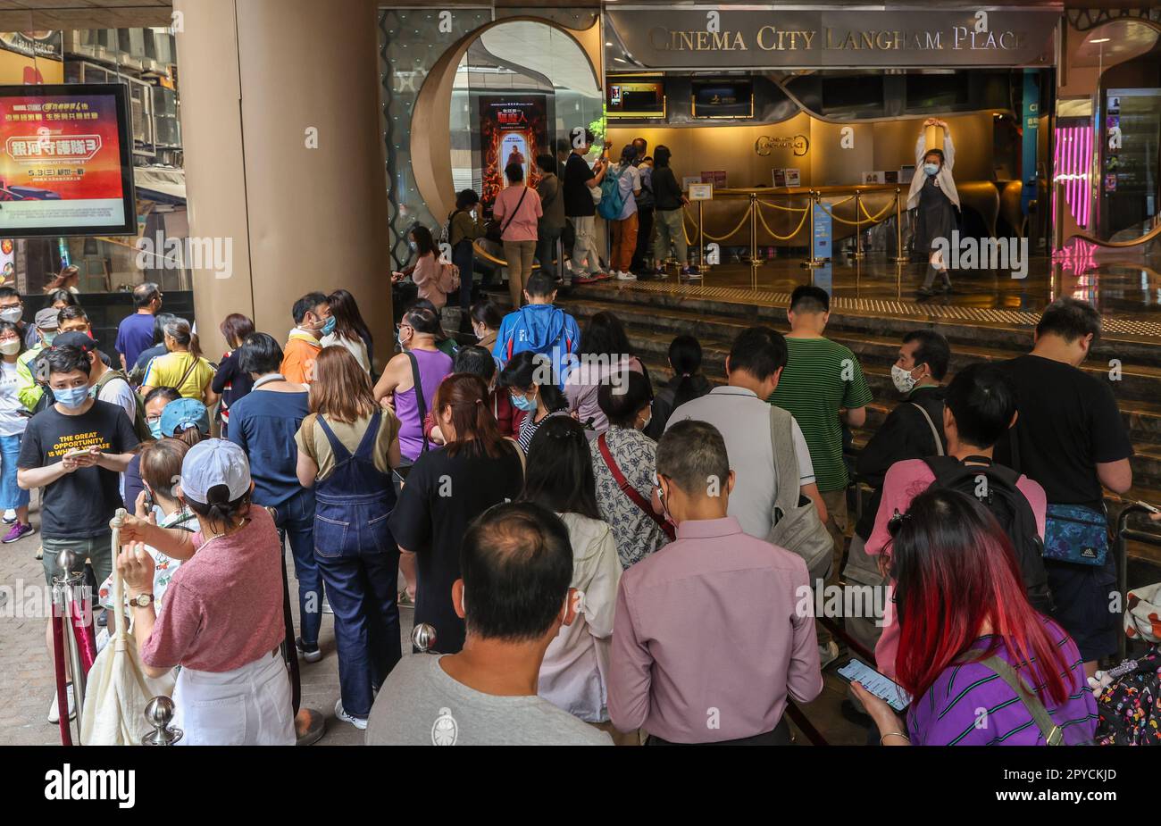 Dozens of people queue up to buy movie tickets outside a cinema in Mong Kok during which tickets ...