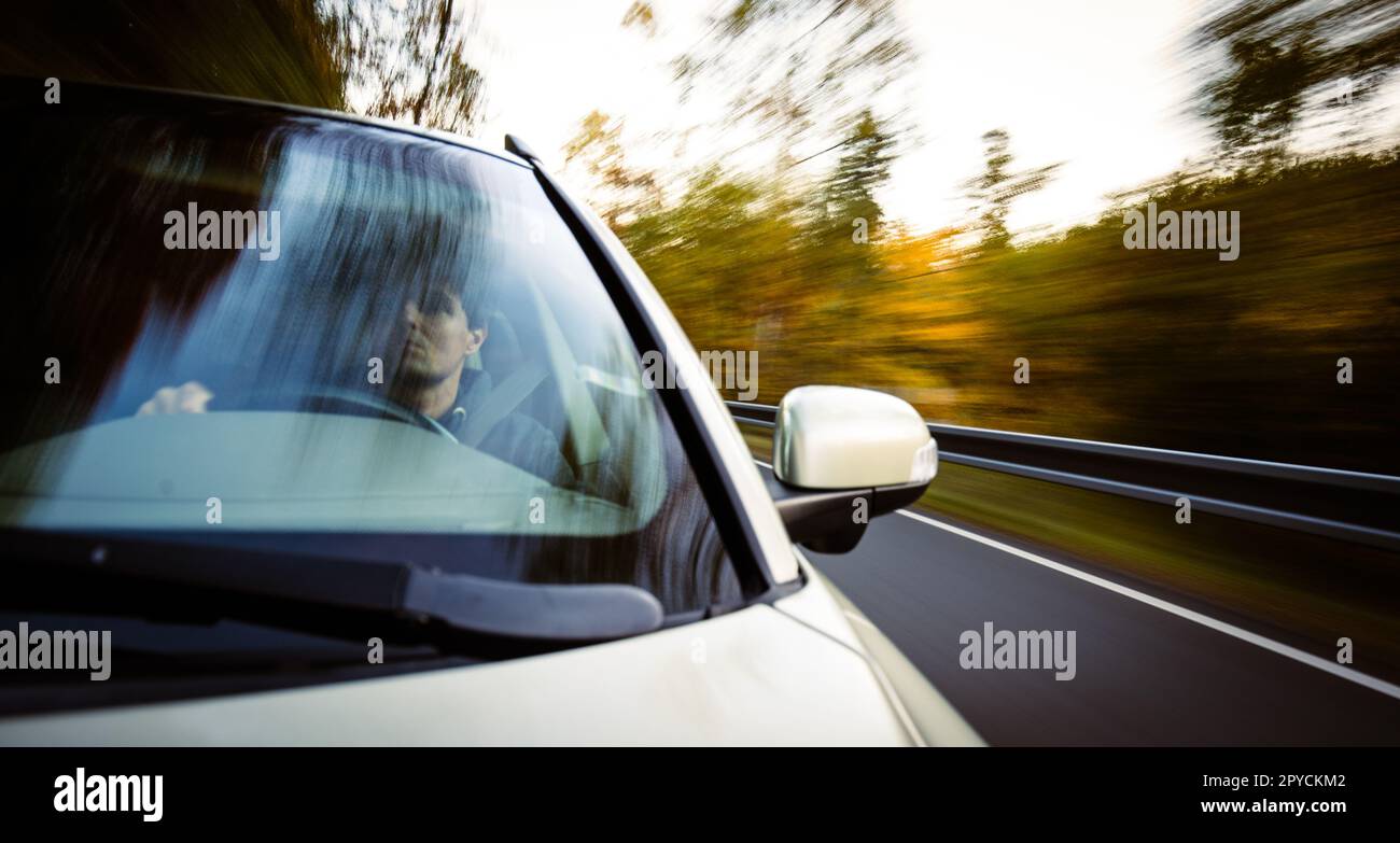 Young man at the steering wheel of his car commuting to work Stock ...