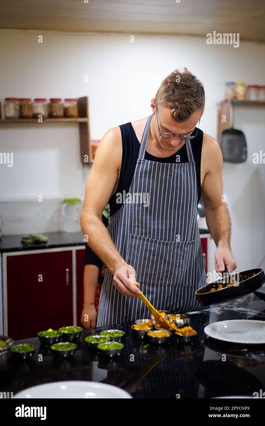 Young indian man preparing lunch hi-res stock photography and images ...