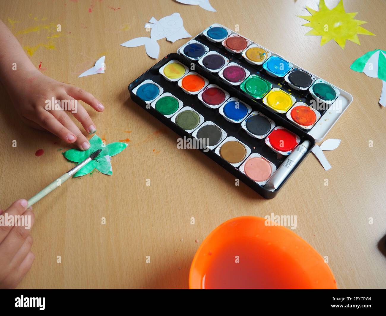 Desktop with drawing tools. Set of watercolor paints. Paper-cut ...