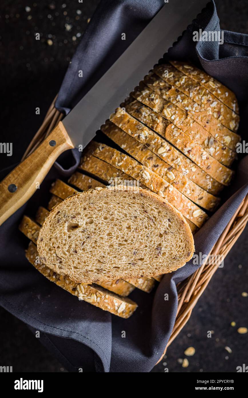 Sliced whole grain bread. Tasty wholegrain pastry with seeds in baket ...