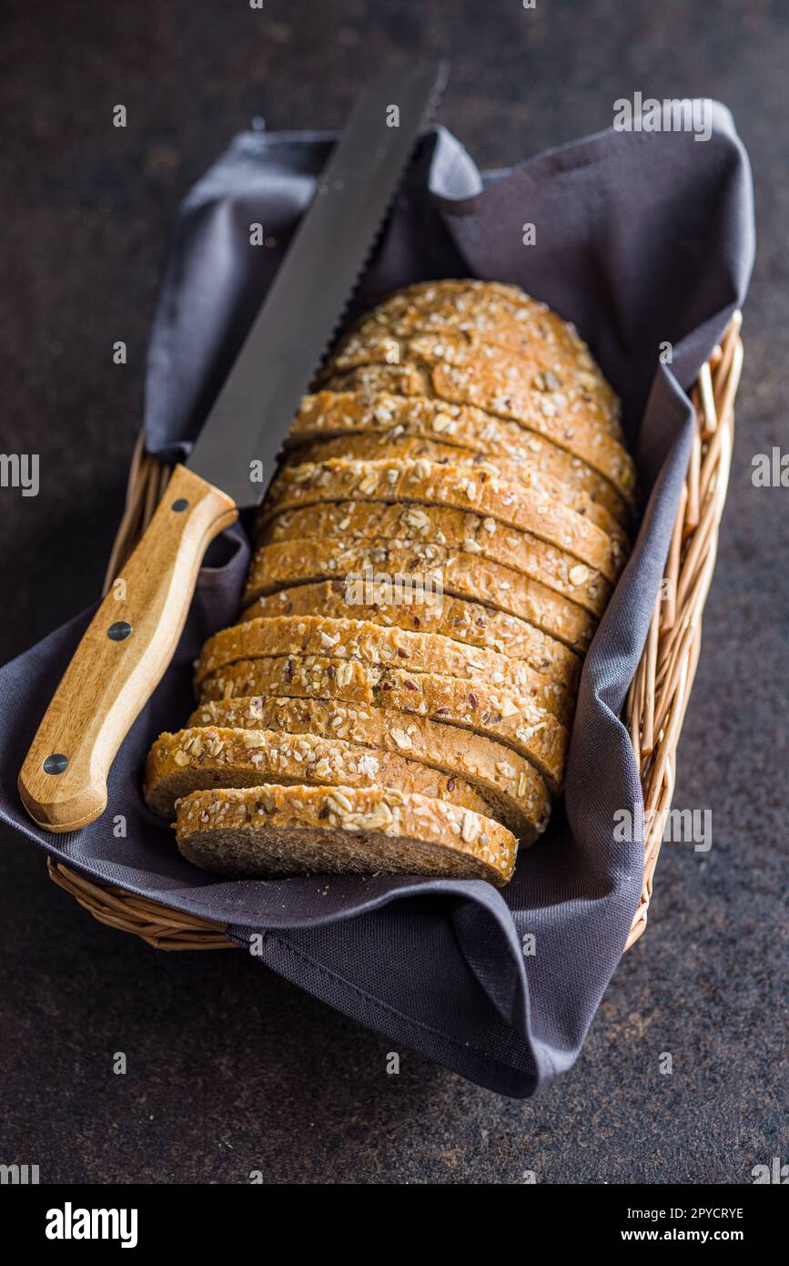 Sliced whole grain bread. Tasty wholegrain pastry with seeds in baket ...