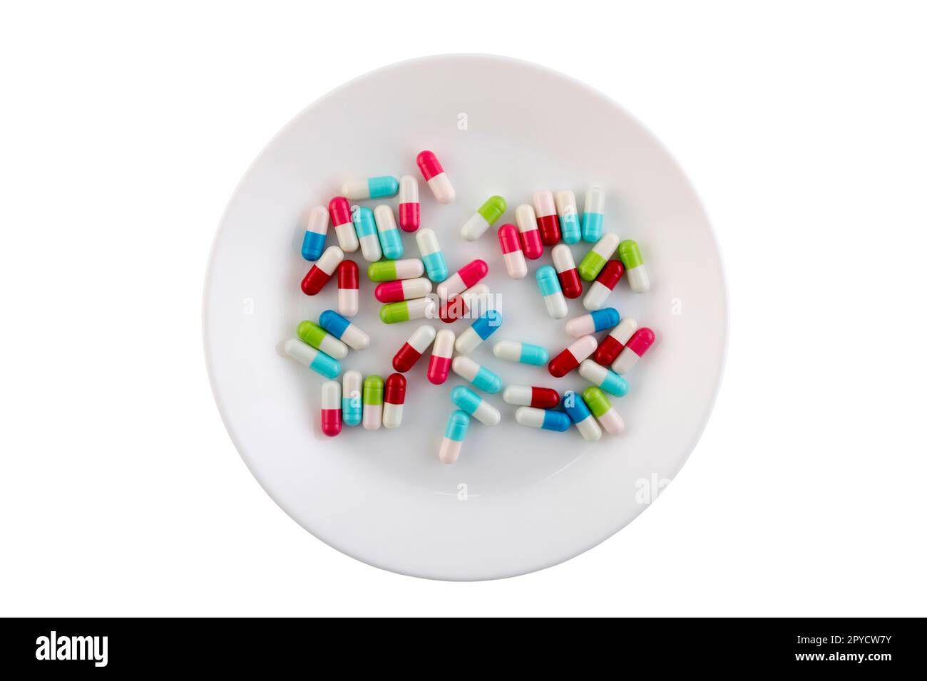 Colorful pills on a plate isolated on white background with clipping ...