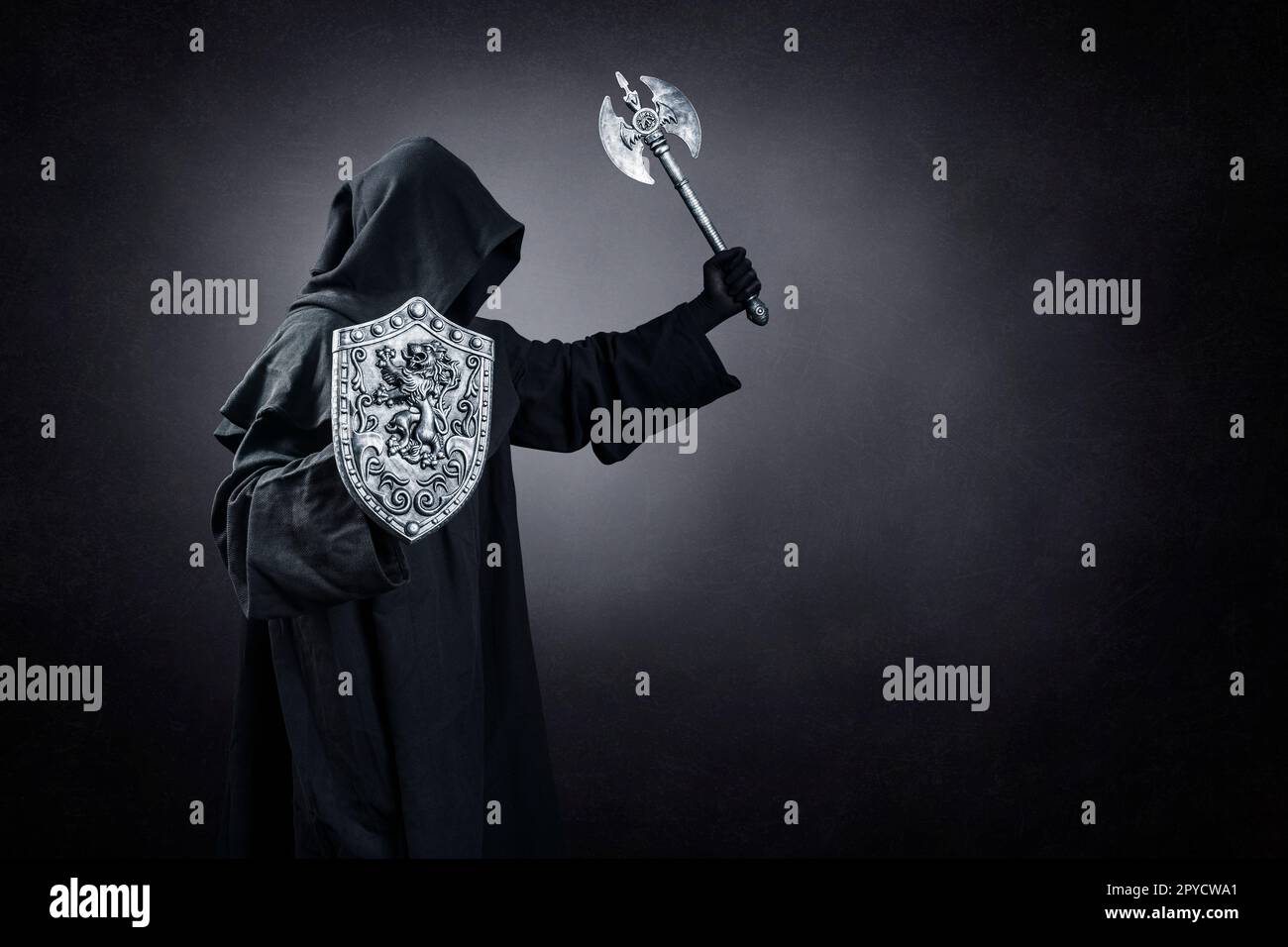 Dark knight with axe and shield over dark misty background Stock Photo ...