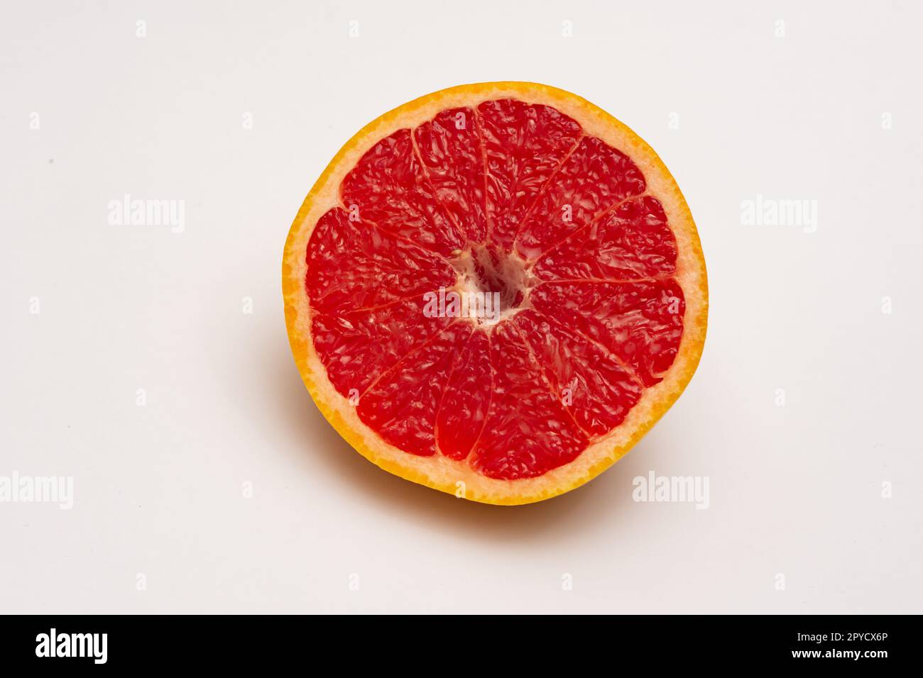 Sliced side of a grapefruit with red pulp isolated on a white ...