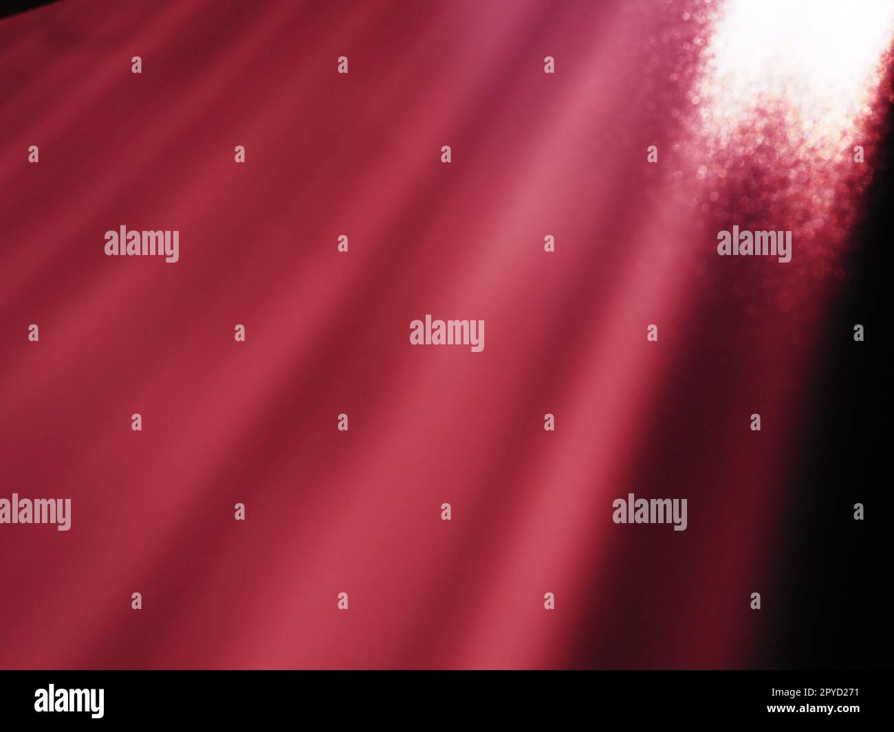 Diagonal rays of light on a red pink or burgundy background. Blurred ...