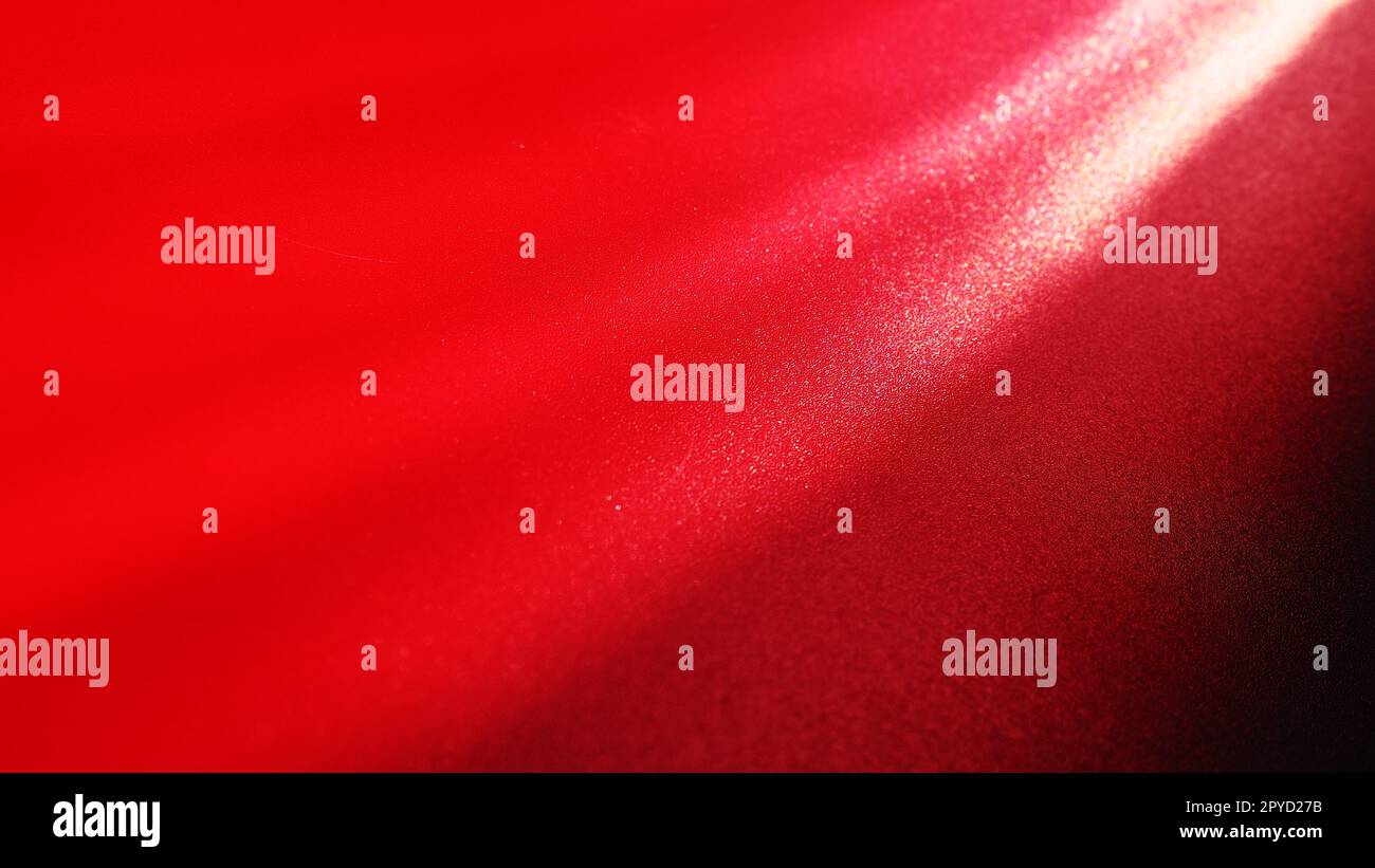 Diagonal rays of light on a red or scarlet background. Blurred abstract ...