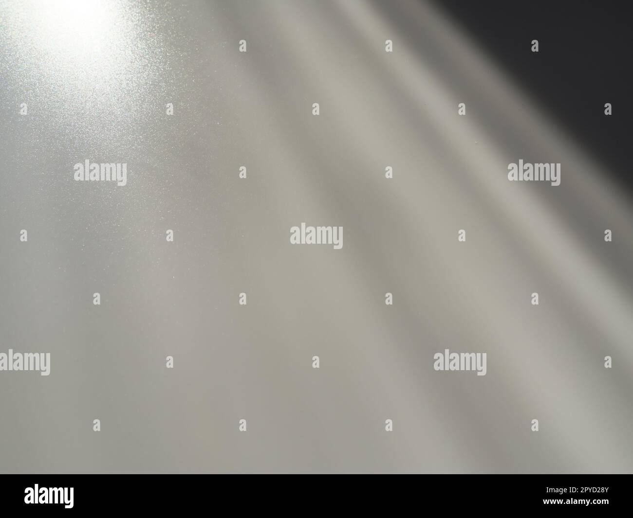 Diagonal rays of light on a gray background. Blurred abstract ...