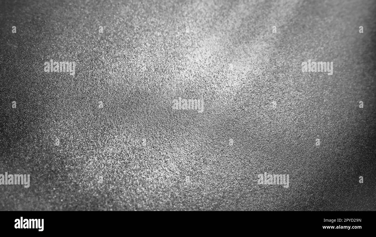 Abstract gray background with gradient, coarse grain. Selective focus ...