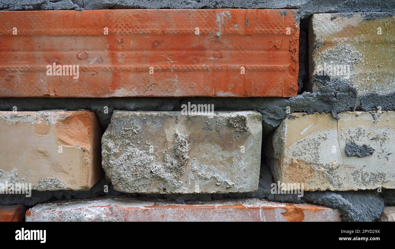 Brick wall. Ceramic masonry or fence. Old, uneven brick, covered in ...