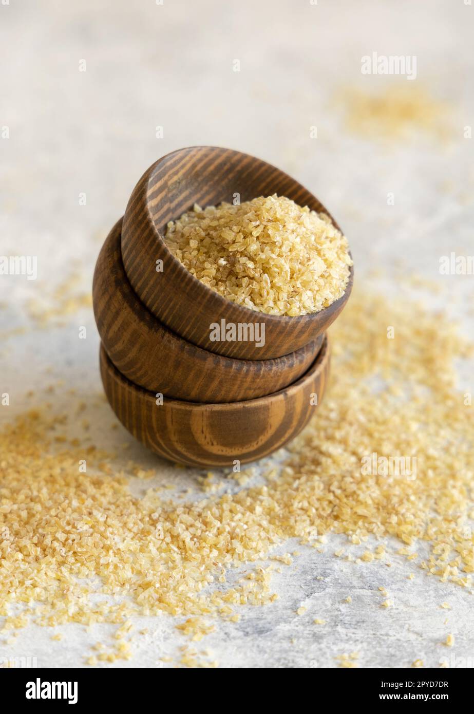Wooden bowls with Dry uncooked bulgur wheat grain close up, copy space ...