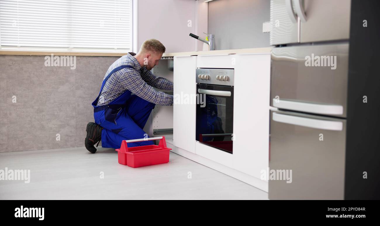 Plumber Cleaning Drain And Pipe Stock Photo - Alamy