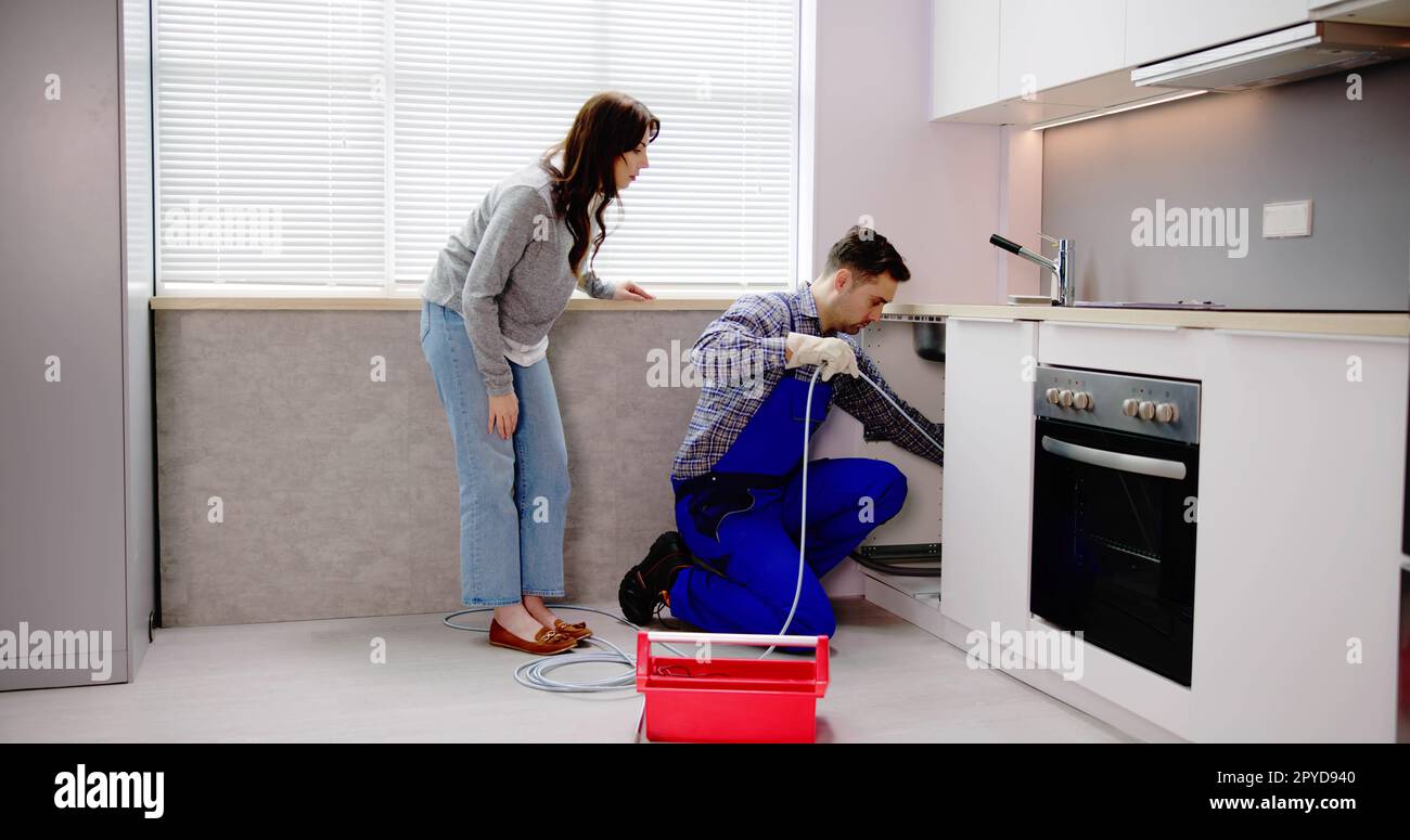 Plumber Cleaning Pipe Drain Clog Stock Photo - Alamy