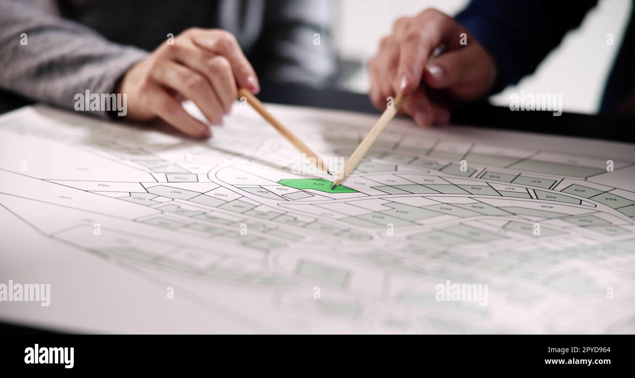 Human Hand Holding Pencil Over Paper Cadastre Stock Photo - Alamy