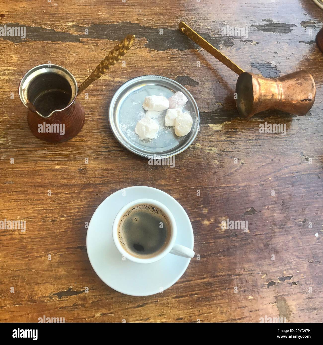 Traditional Greek coffee set on a wooden table next to copper coffee ...