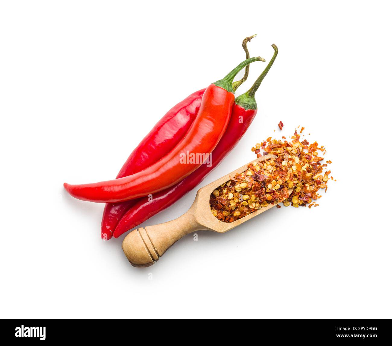 Dry chili pepper flakes in wooden scoop. Crushed red peppers isolated ...