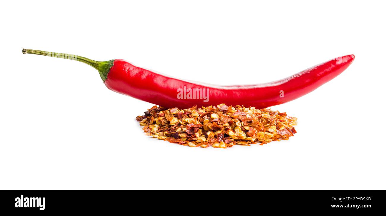 Dry chili pepper flakes and chili peppers. Crushed red peppers isolated ...