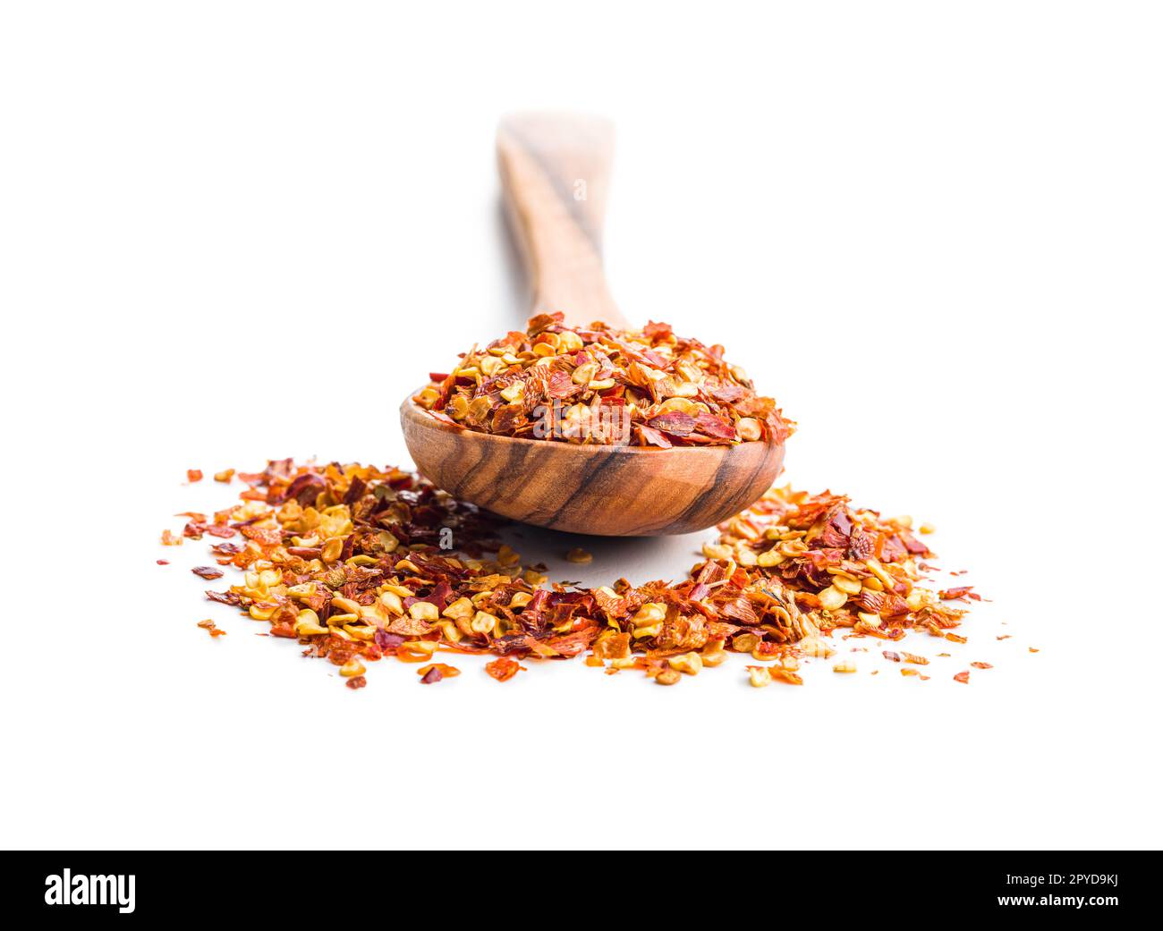Dry chili pepper flakes in spoon. Crushed red peppers isolated on white ...