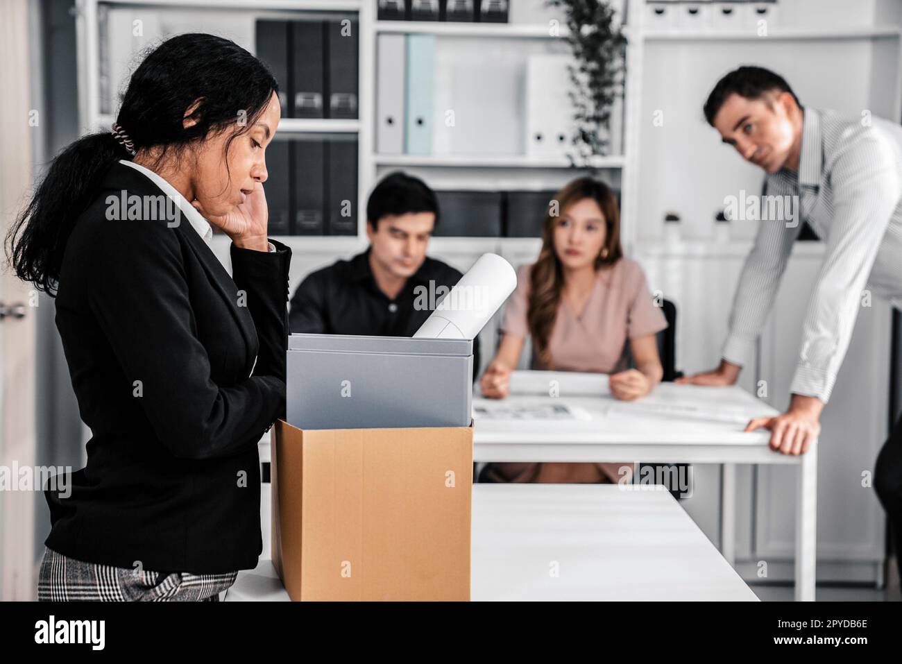 Depressed and disappointed employee packing her belongings after being ...
