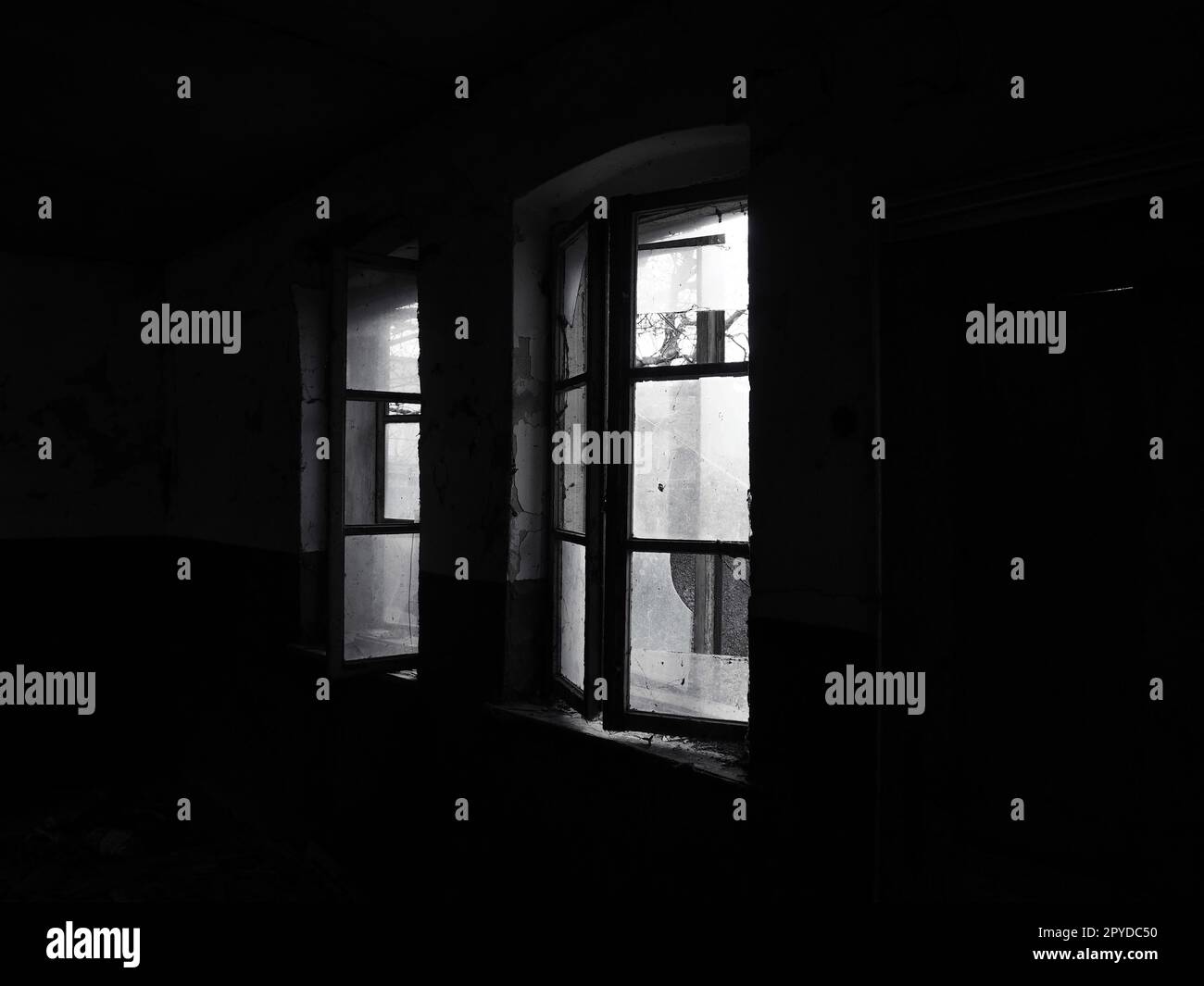 Scary windows. Inside an abandoned house. View of broken windows ...