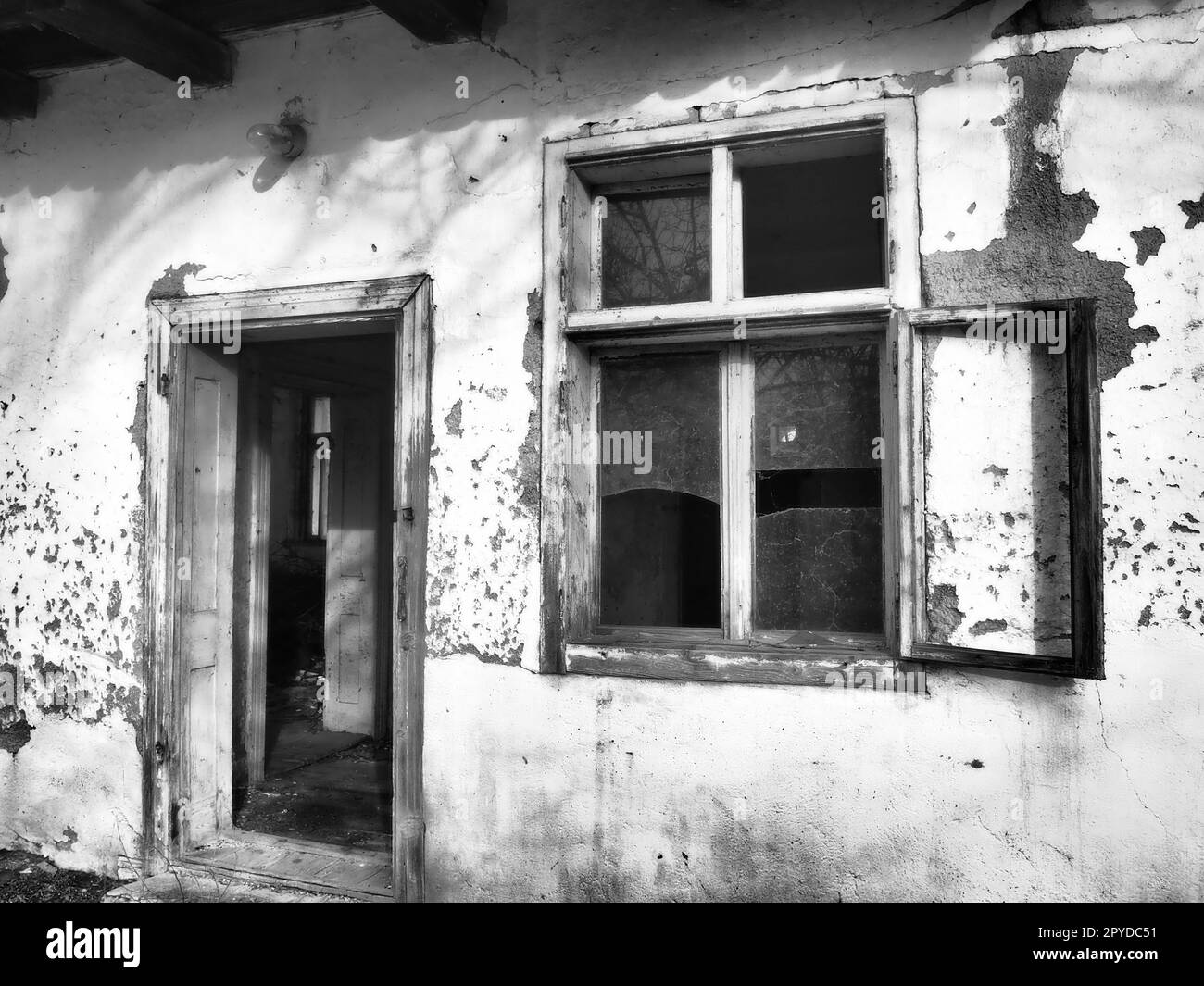 Old house with windows and a door. Collapsing rural house. The concept ...