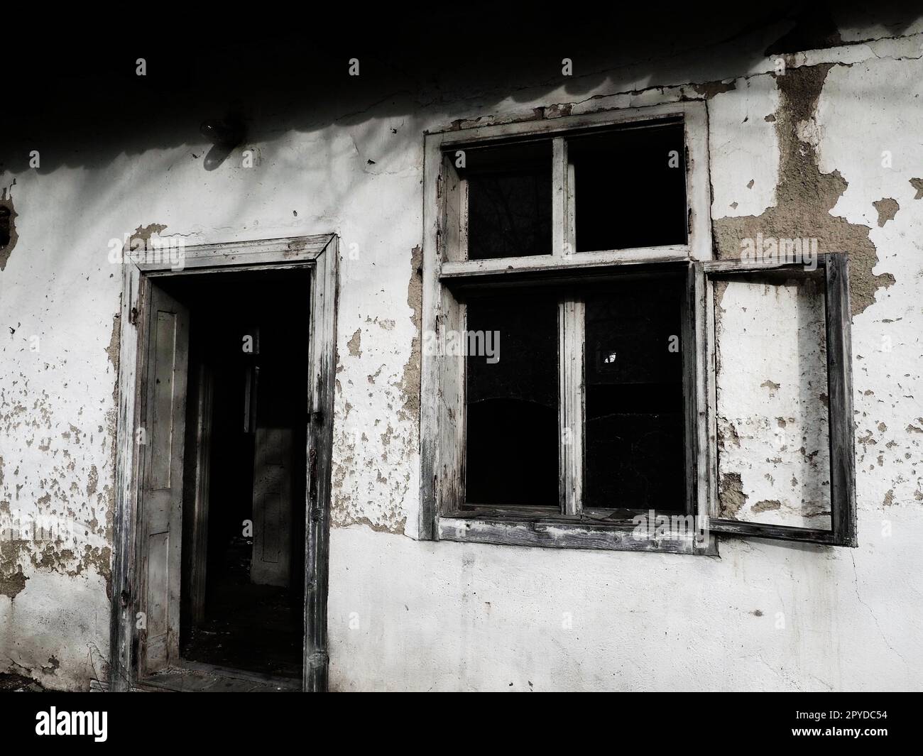 Old house with windows and a door. Collapsing rural house. The concept ...