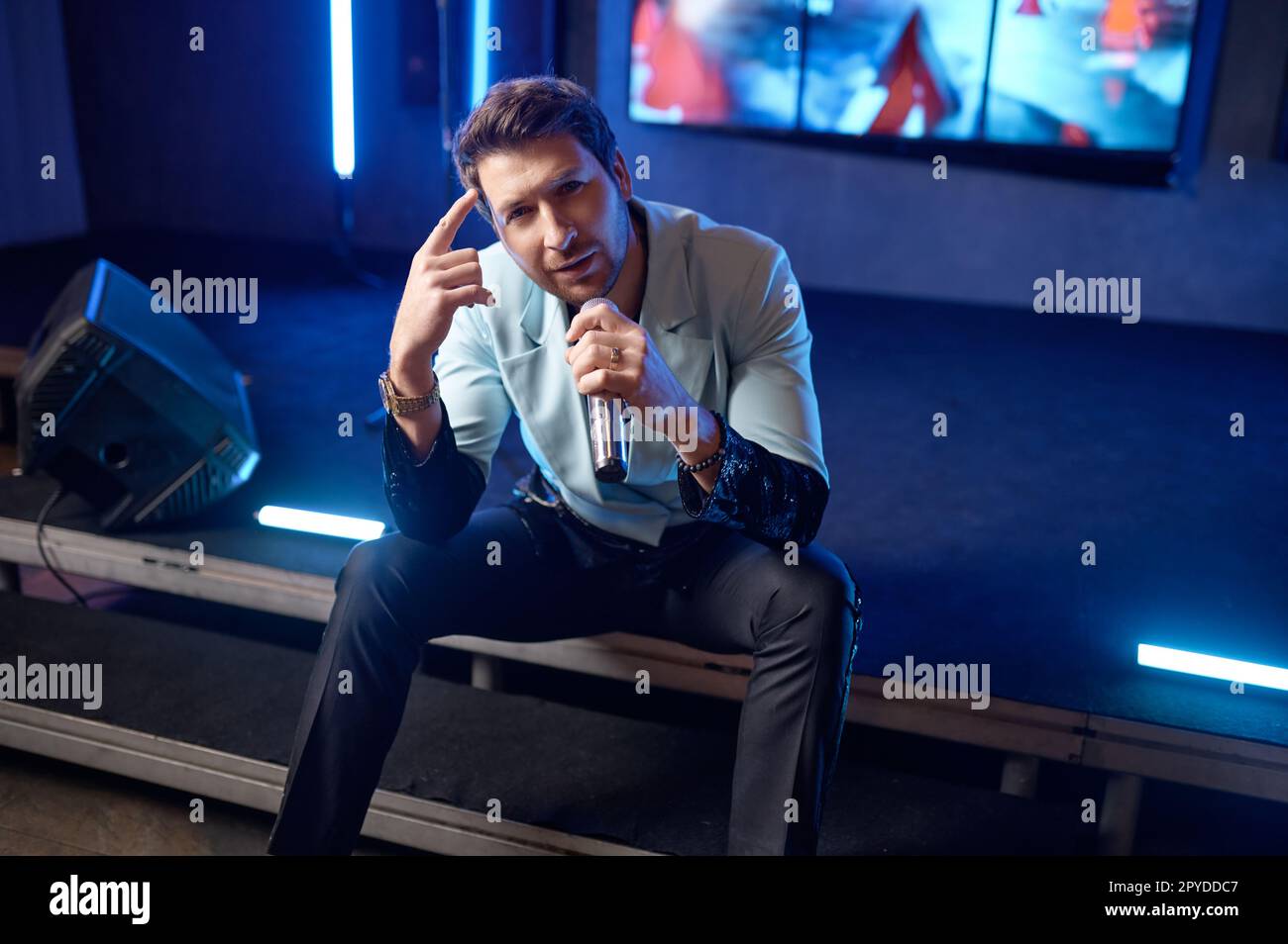 Male singer performing on stage at music concert Stock Photo - Alamy