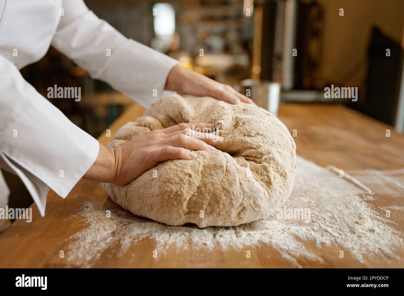Baking process, closeup baker hands kneading dough on table Stock Photo ...