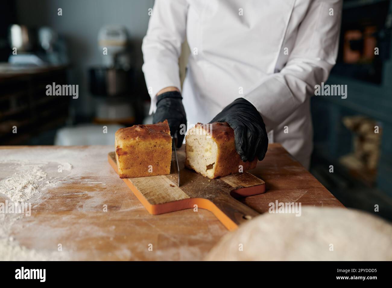 Woman cutting fresh buckwheat bread hi-res stock photography and images ...