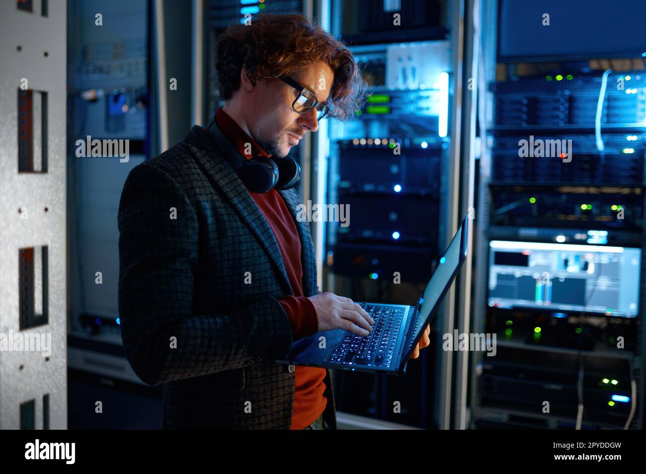 IT technician checking the servers vitals using laptop computer Stock ...