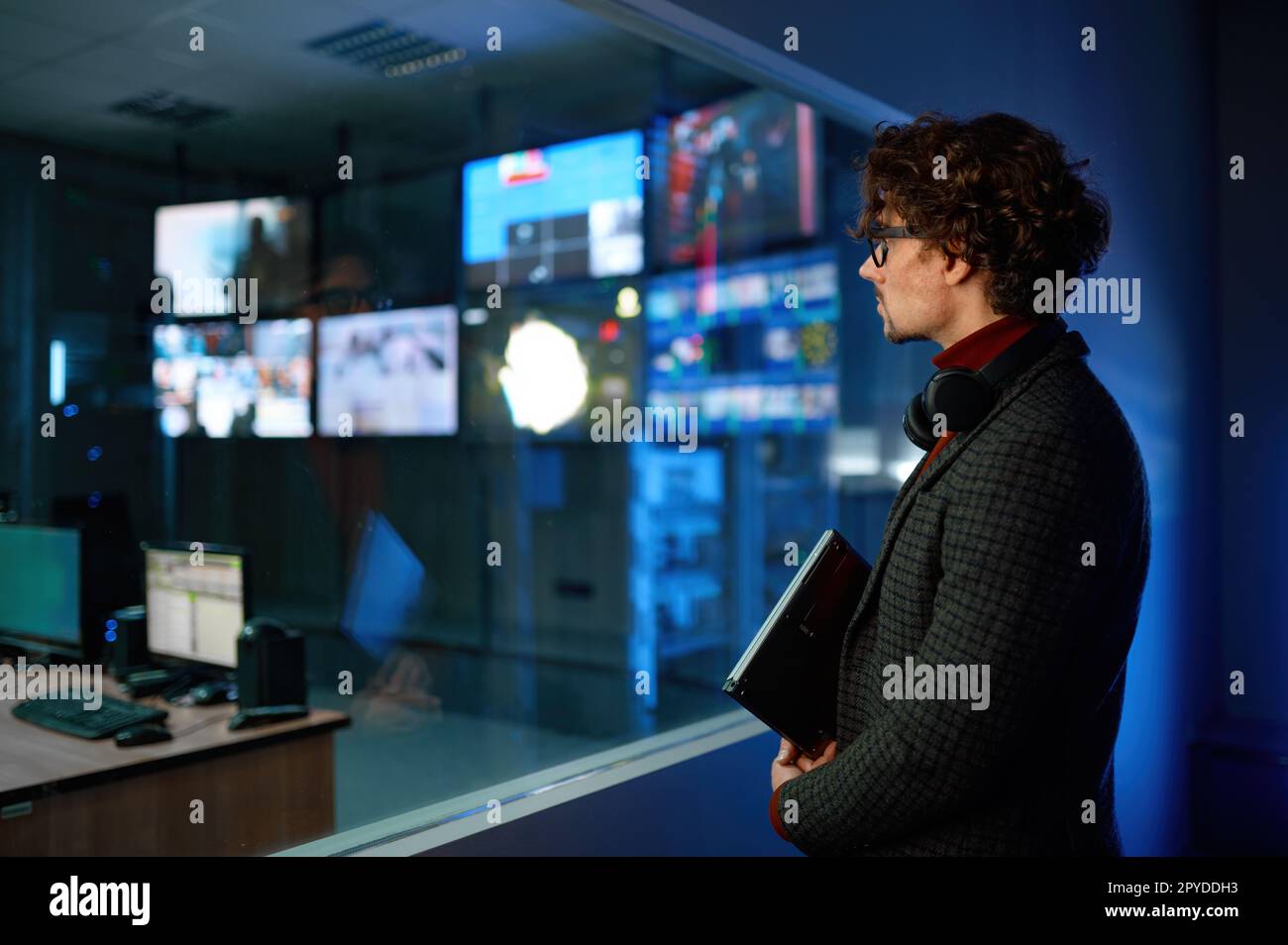 Man looking at computer screen reflection in server room window Stock ...