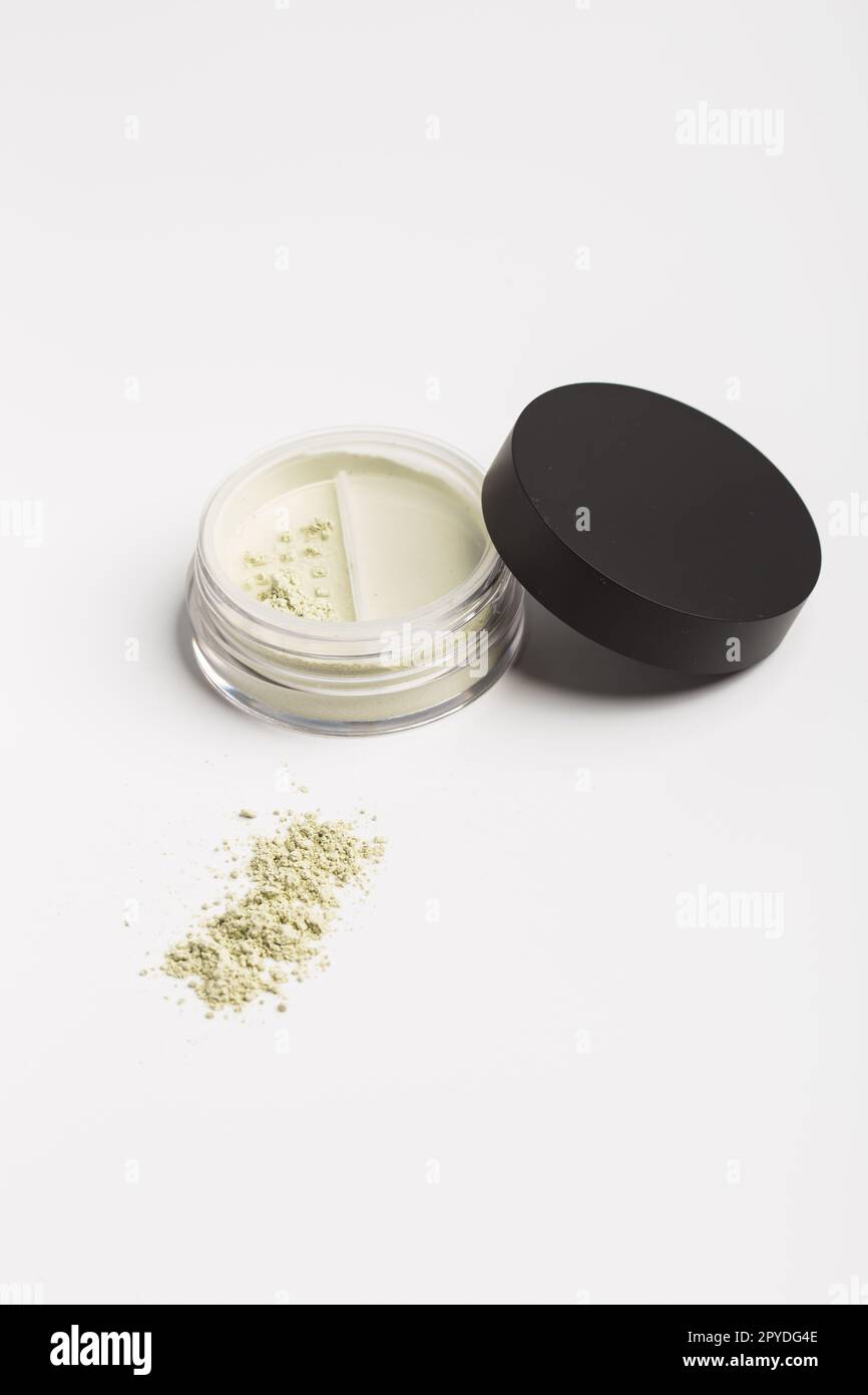 Green cosmetic mineral powder for face on container with twist seal ...