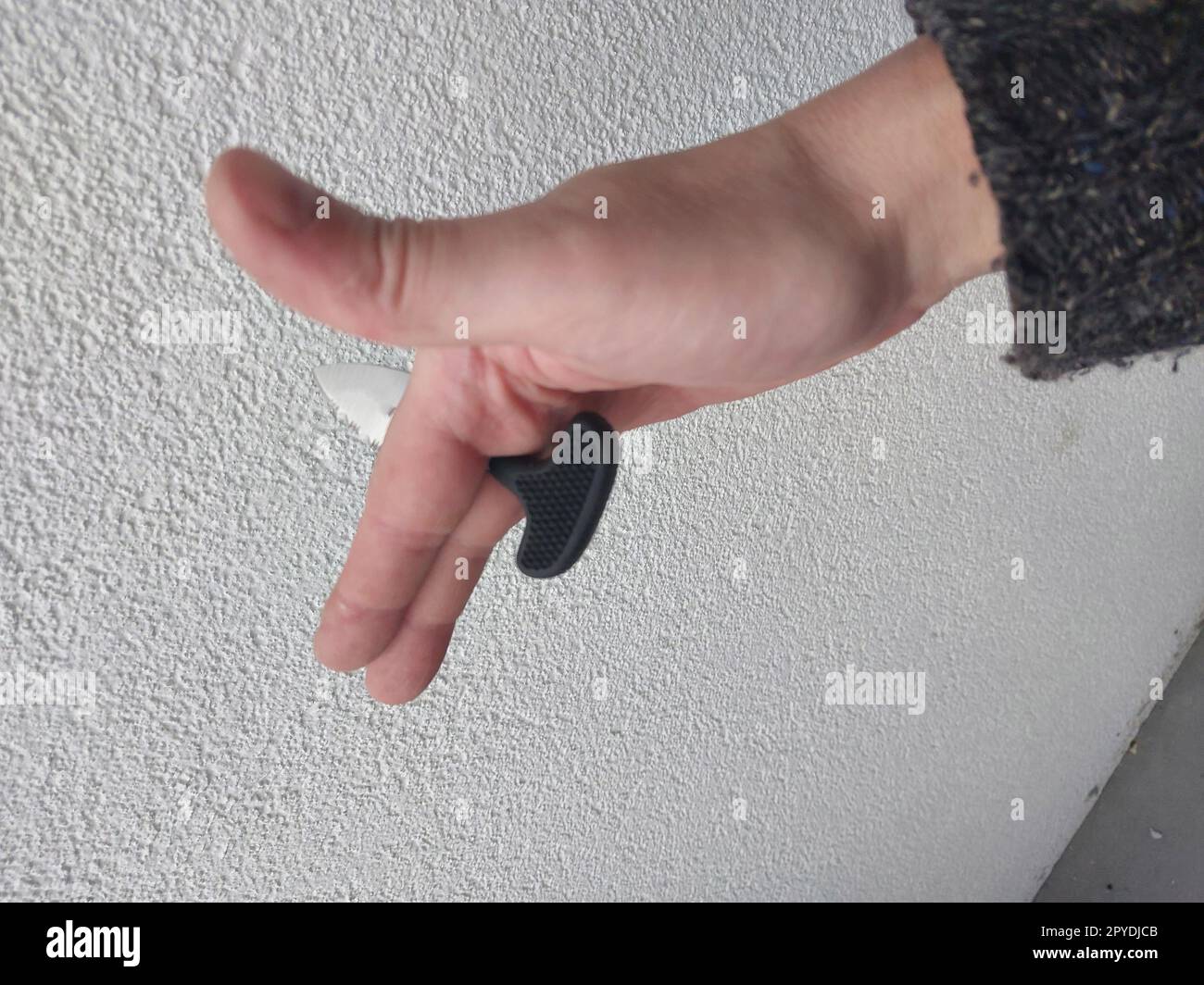 Poke knife for self-defense in the hand of a man Stock Photo - Alamy