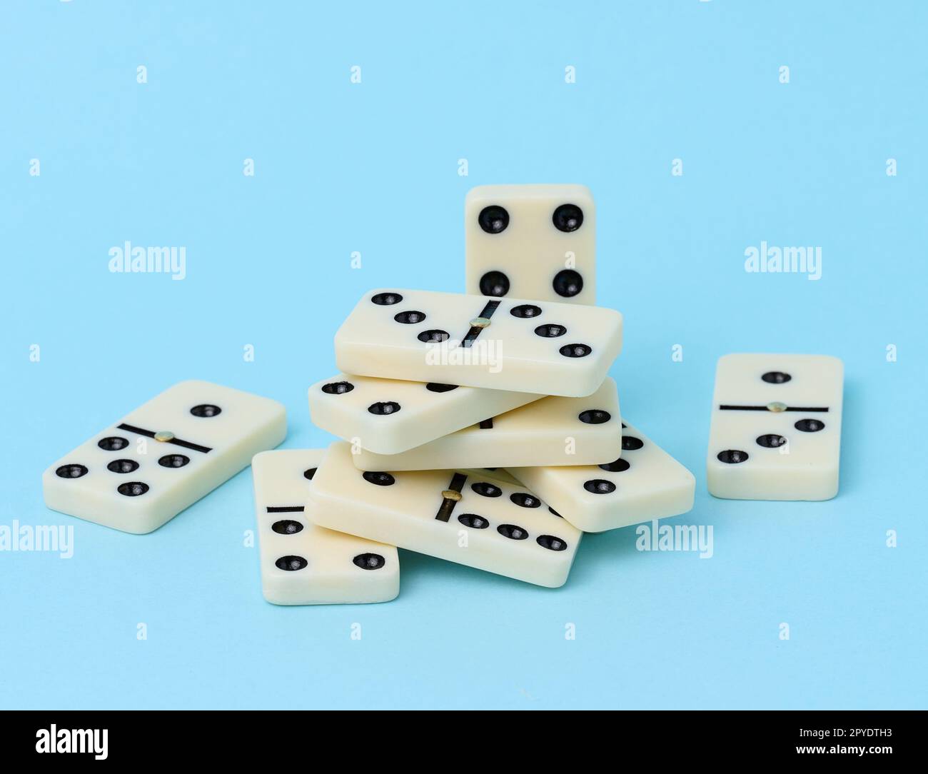 A stack of dominoes on a blue background, an intellectual game Stock ...