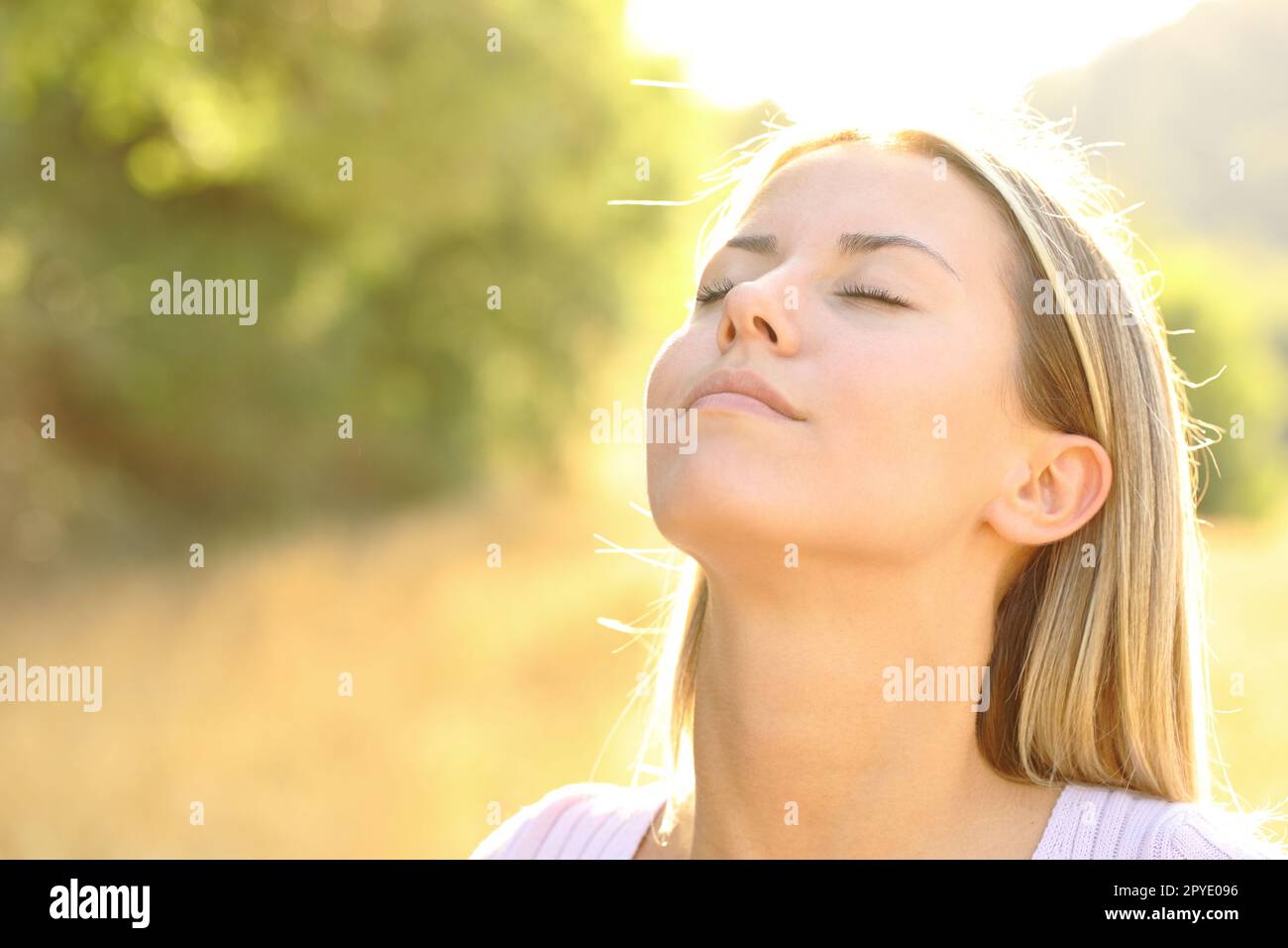 Relaxed beautiful woman breathing in nature Stock Photo - Alamy