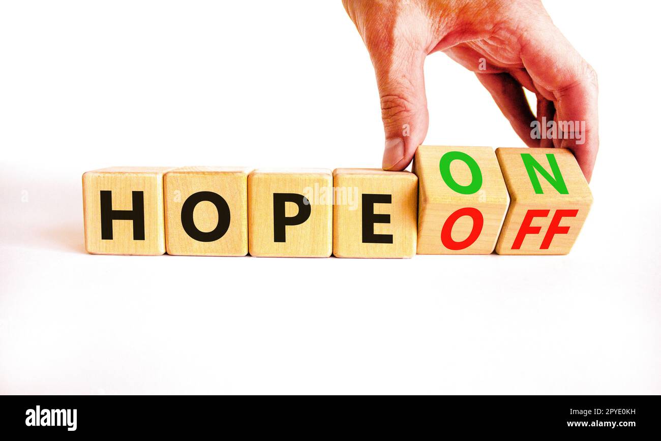 Hope on or off symbol. Businessman turns wooden cubes and changes word ...