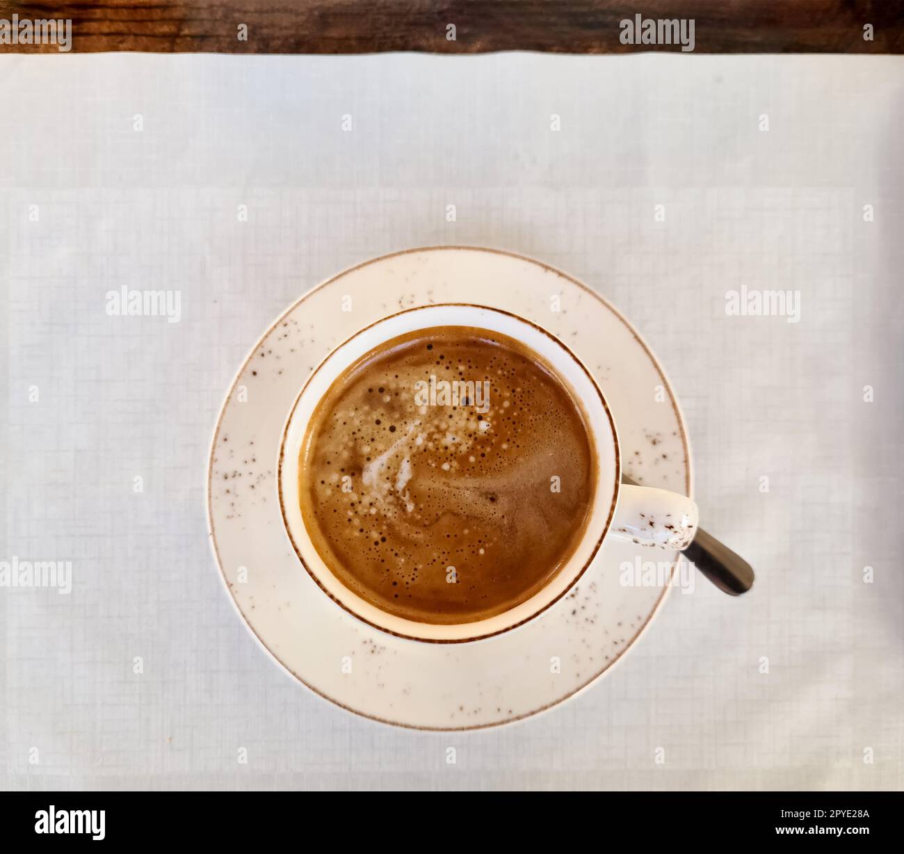 Top view of a cup of Cafe Crema on a white doily Stock Photo - Alamy