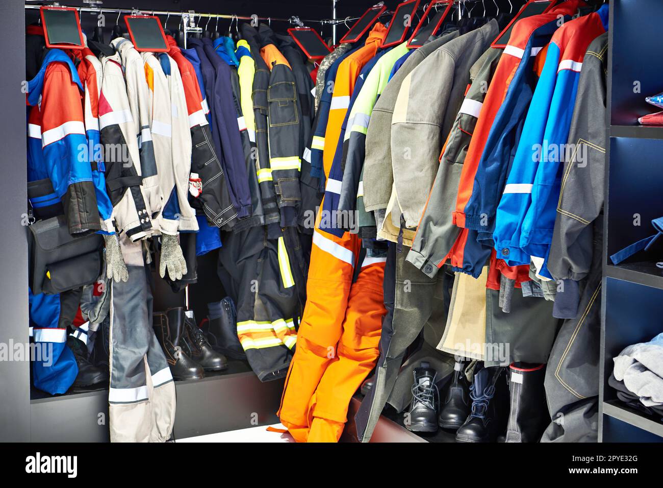 Wardrobe with hangers for industrial workwear Stock Photo - Alamy